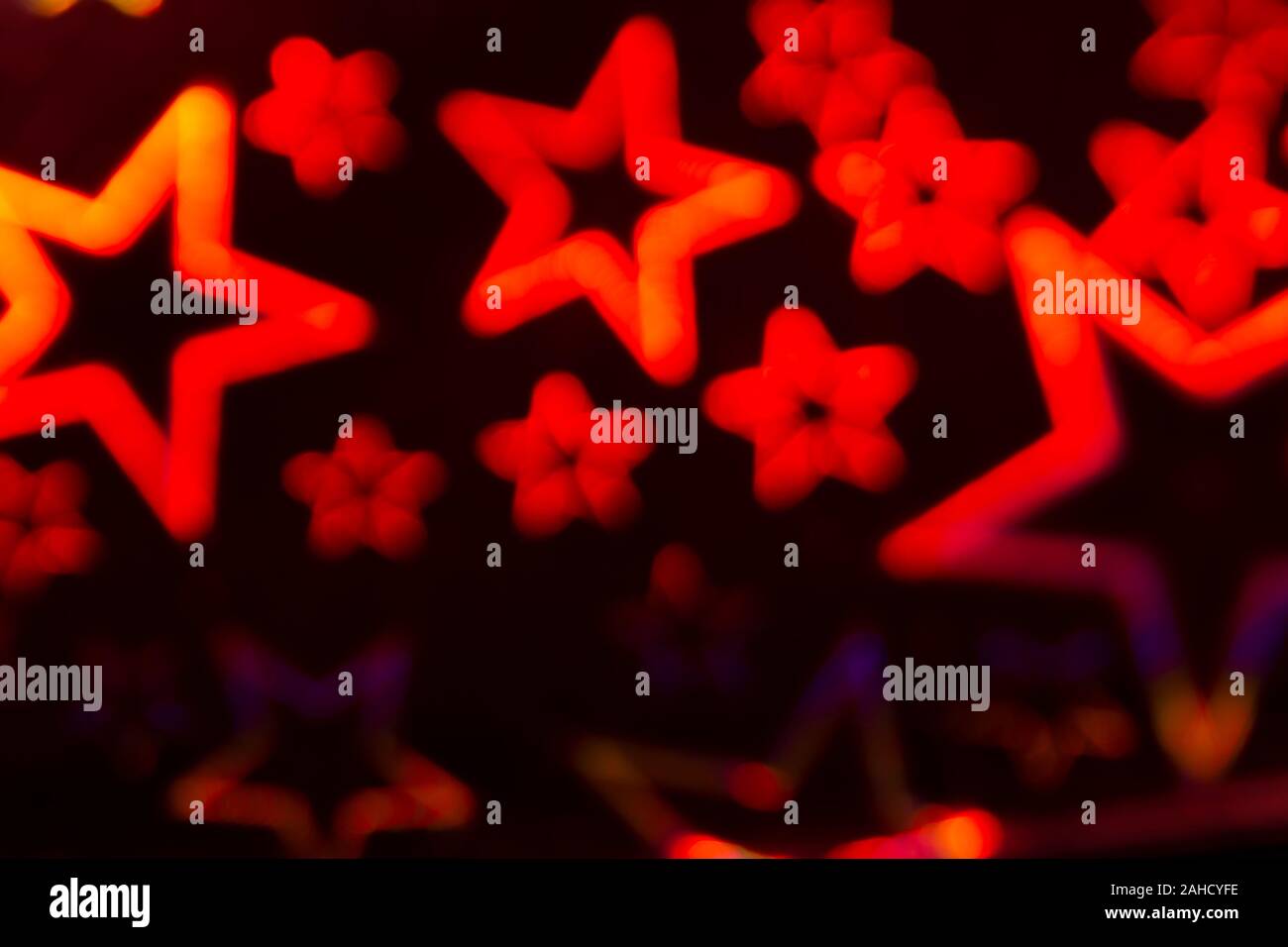 abstract background with defocused red star shapes, party template with ...