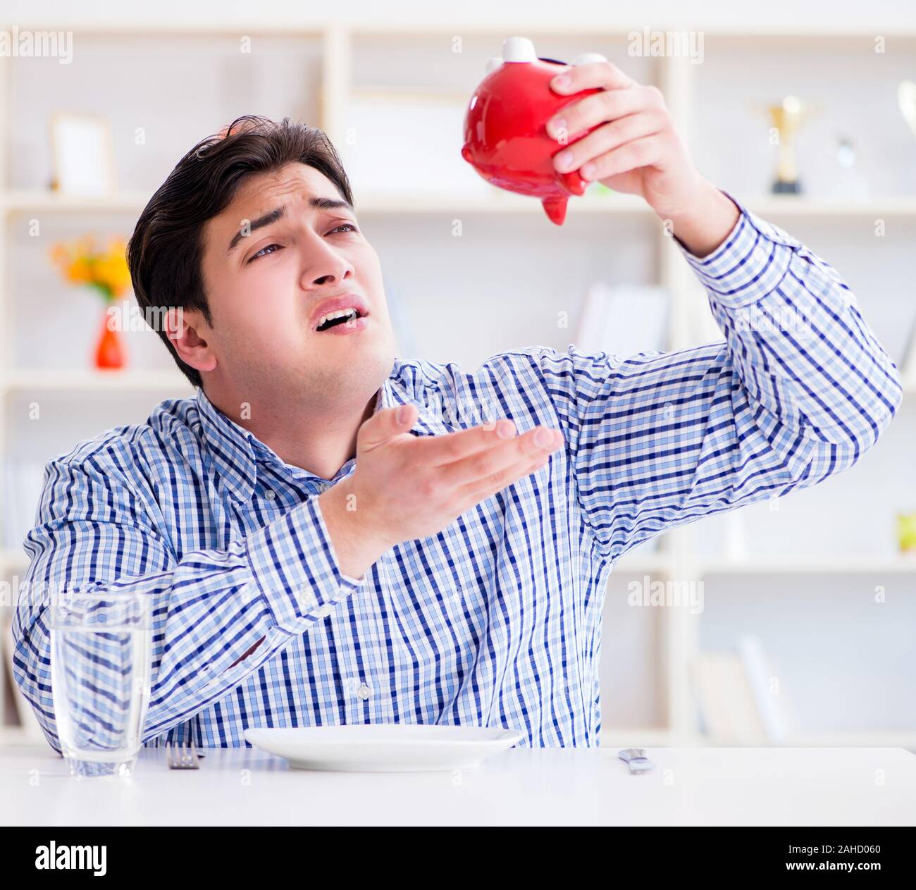 Man running out of money in restaurant and using savings from piggy ...
