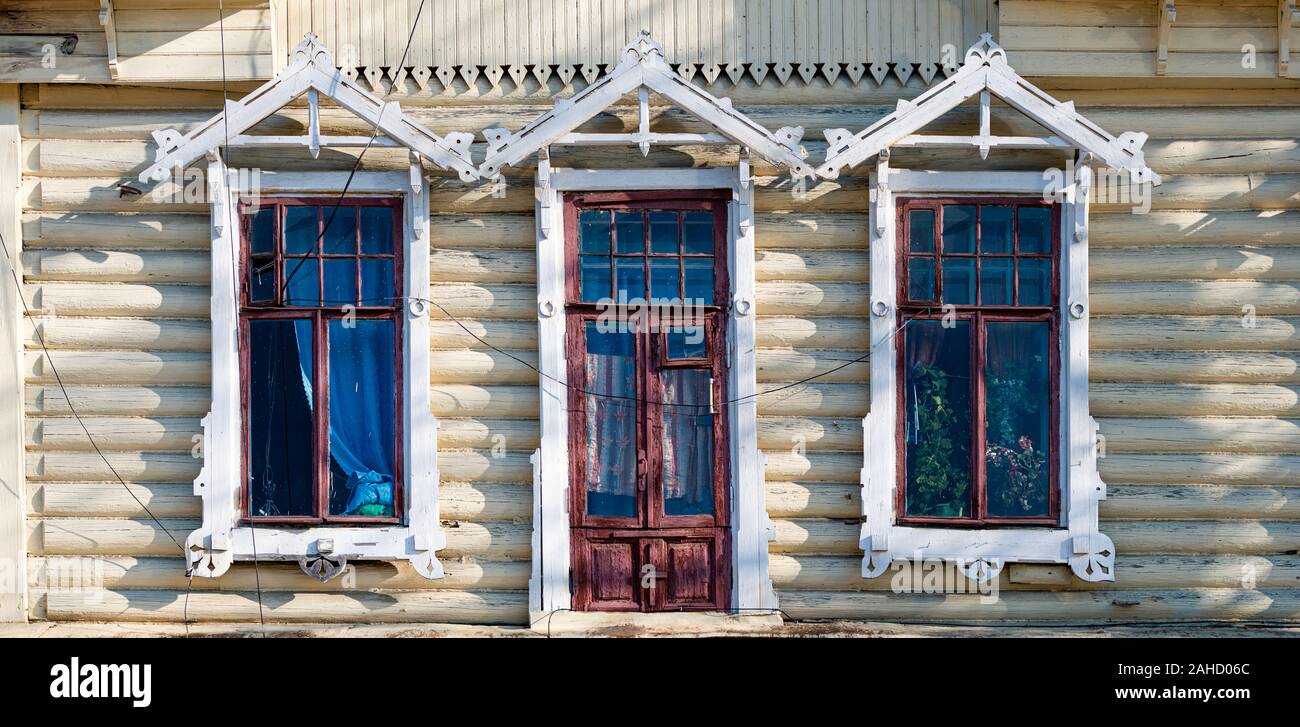Old wood log background with cracks and lines. Windows on wall of house ...