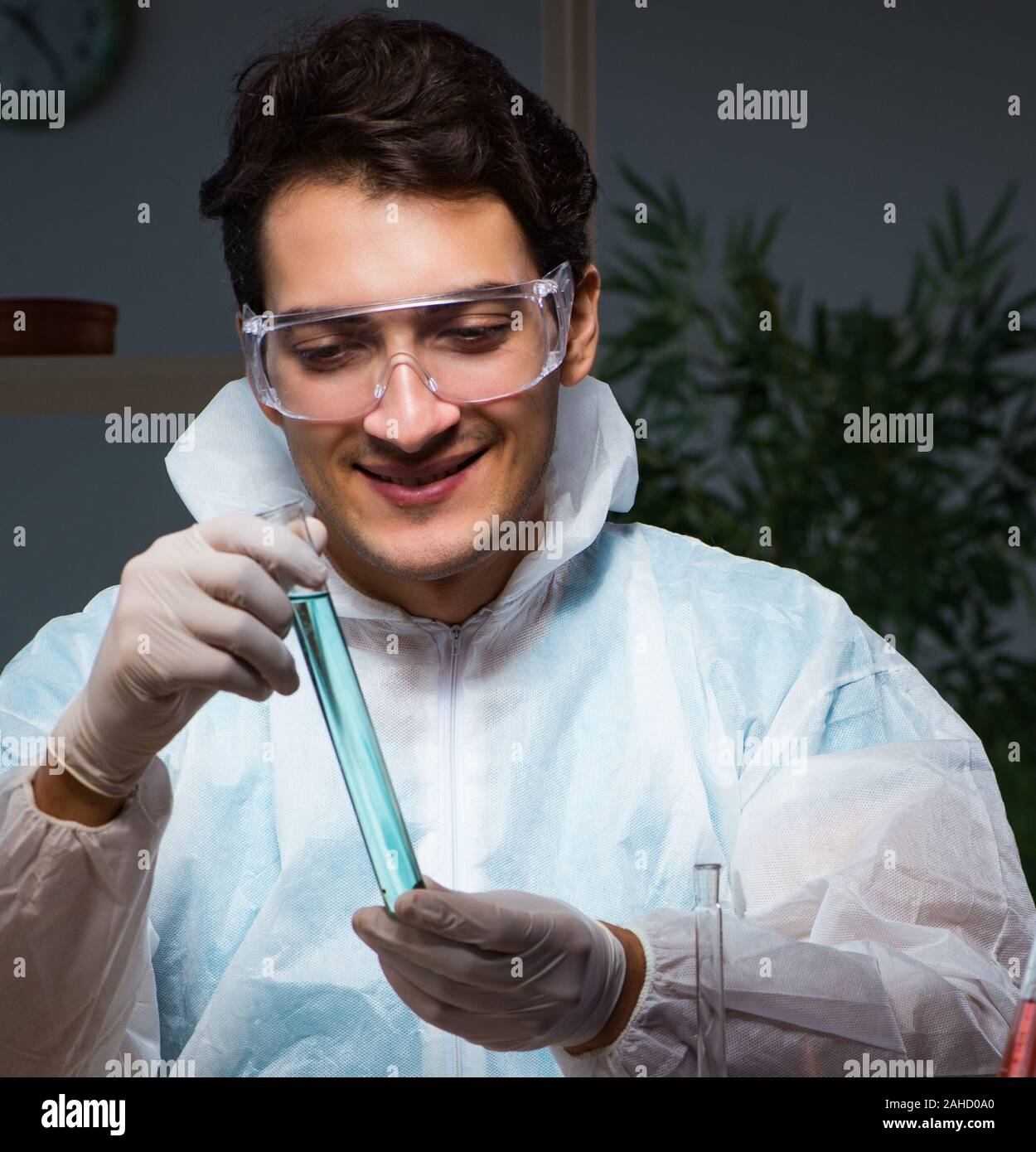 The young male lab chemist late at night in overtime time Stock Photo ...