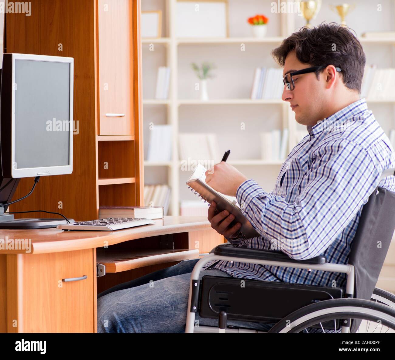 The disabled student studying at home on wheelchair Stock Photo - Alamy