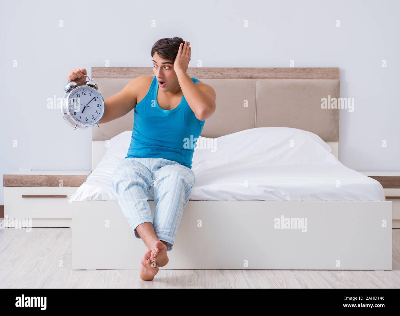 The young man waking up in bed Stock Photo - Alamy