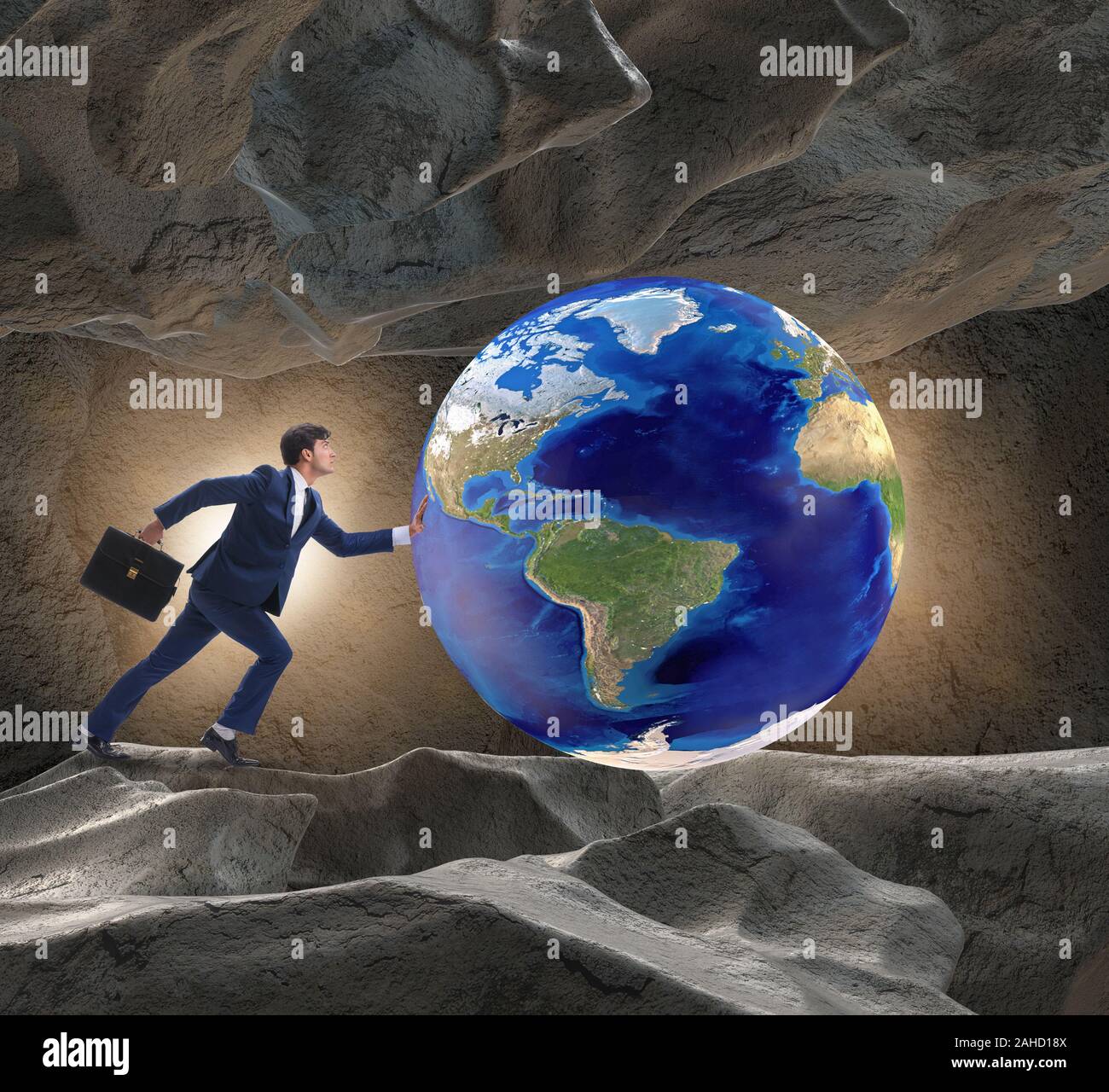 The businessman pushing the world in challenge concept Stock Photo - Alamy