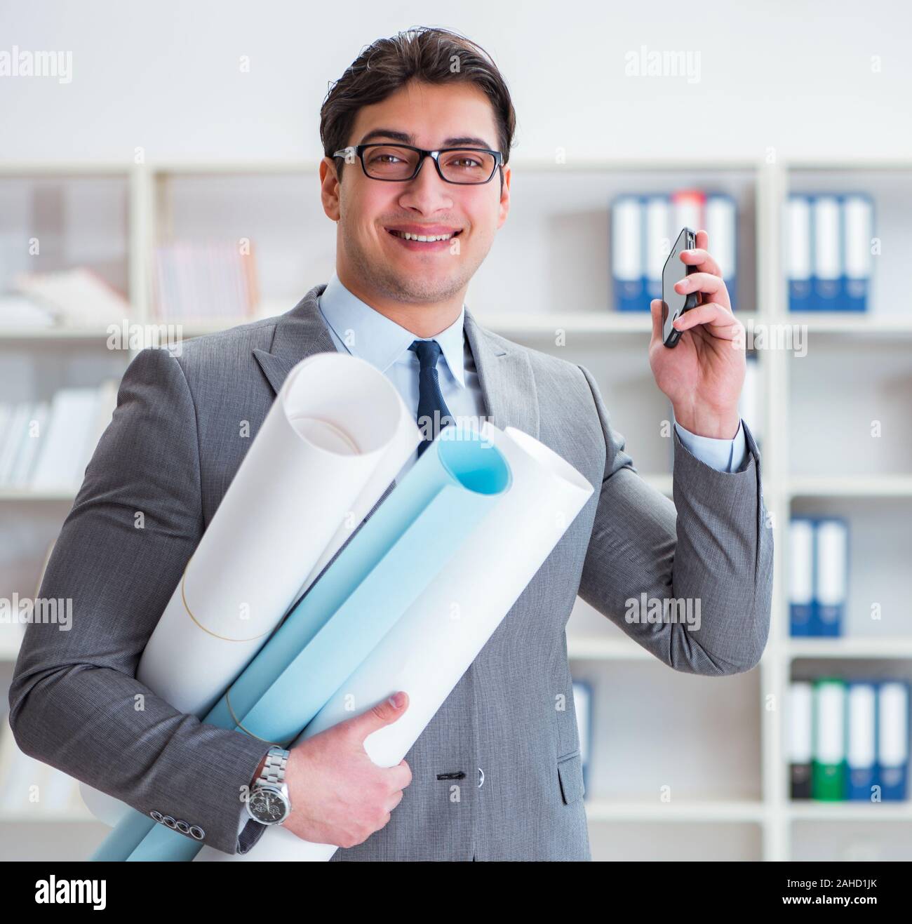 The businessman engineer draftsman with blueprints drawings Stock Photo ...