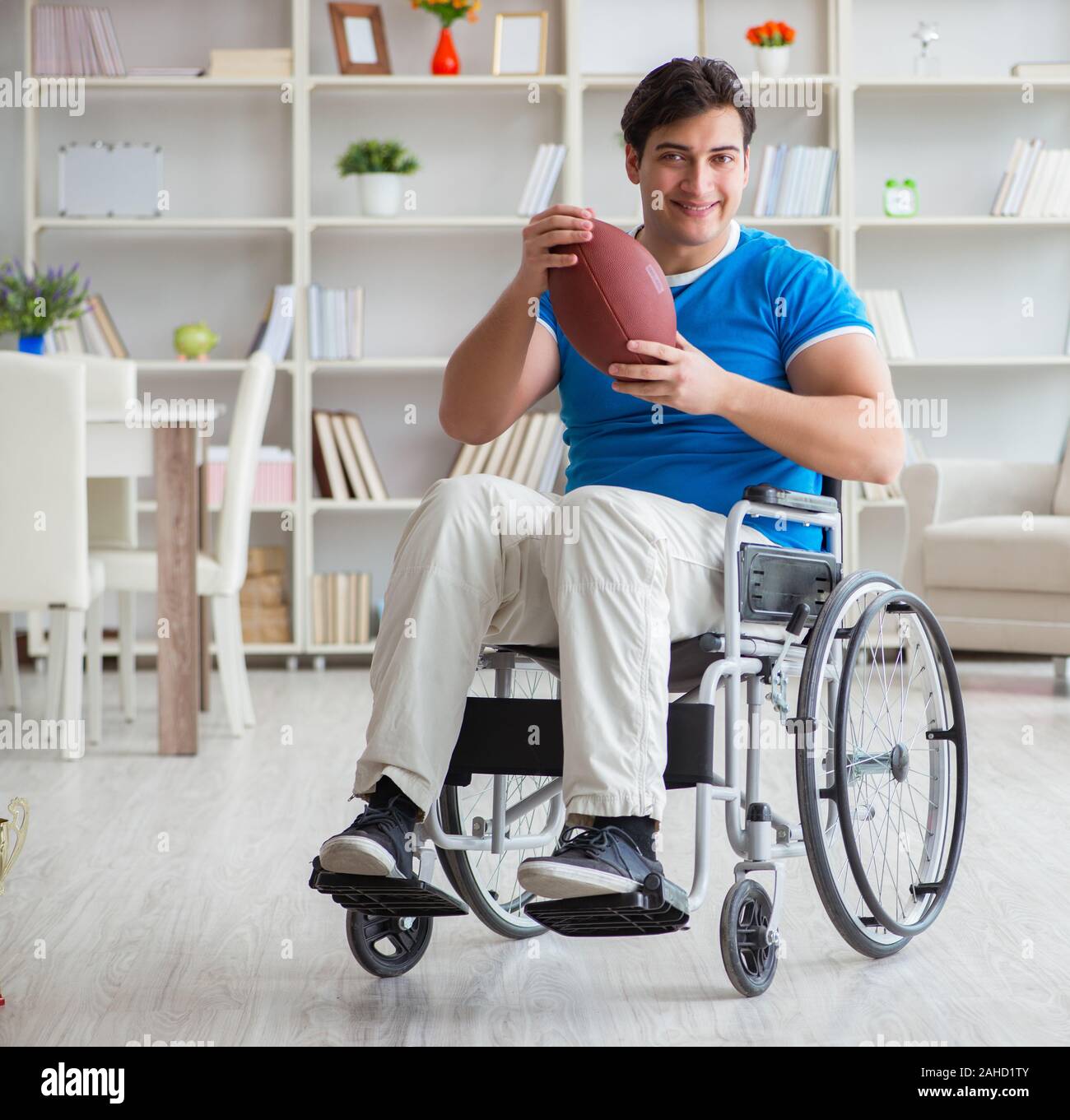 The young man american football player recovering on wheelchair Stock ...