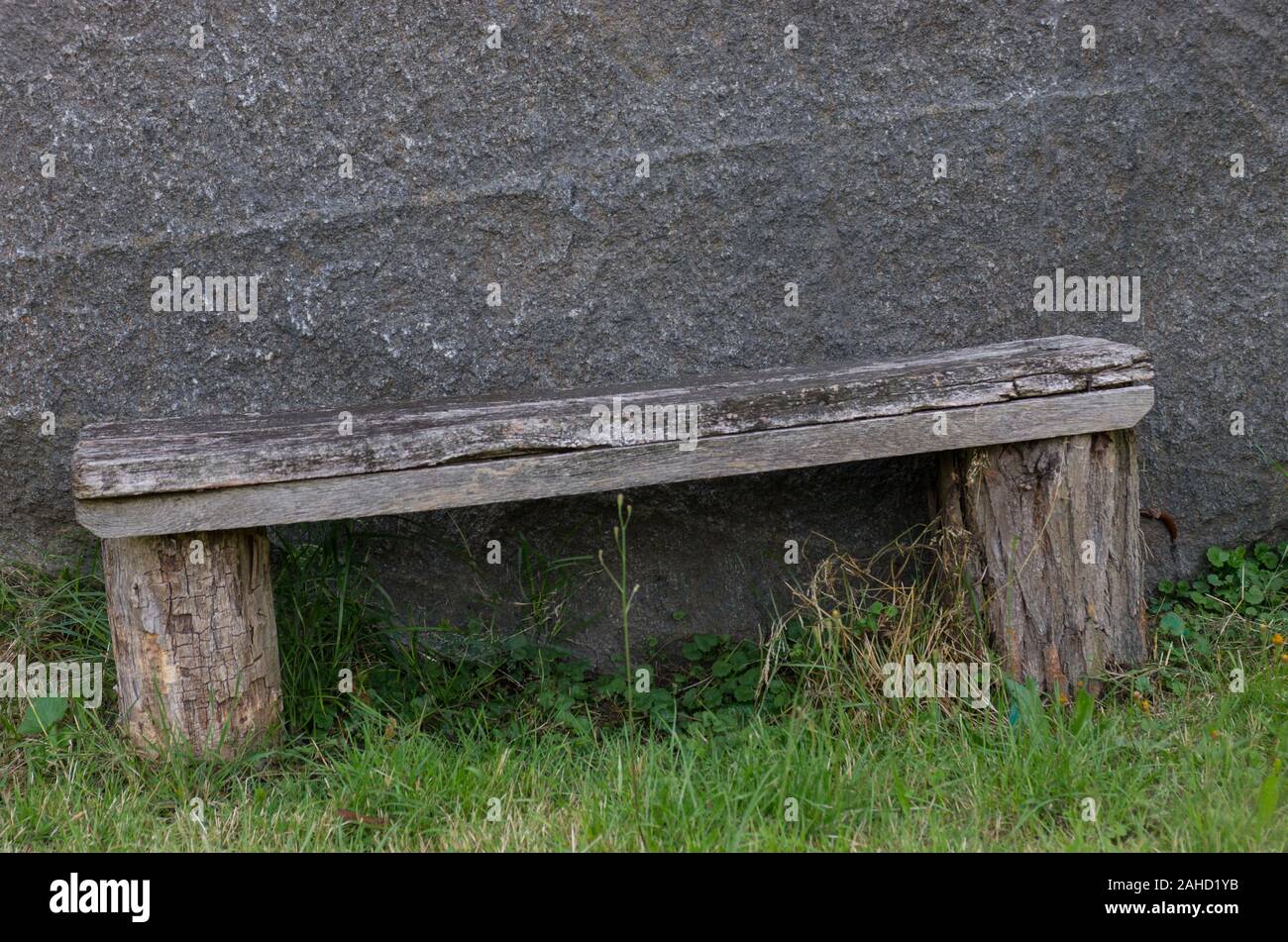 Huge boulder and old bench in the garden Stock Photo - Alamy