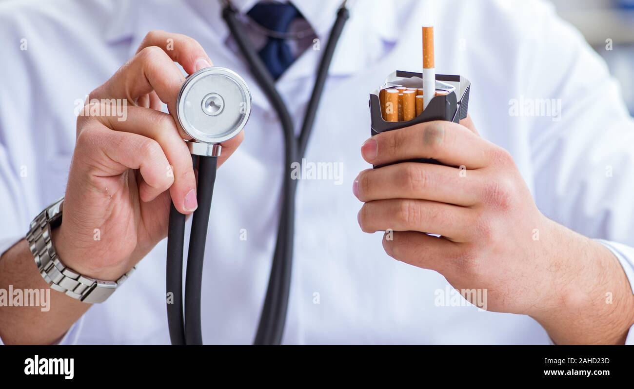 The male doctor in anti-smoking conceptwithcigarette pack Stock Photo ...