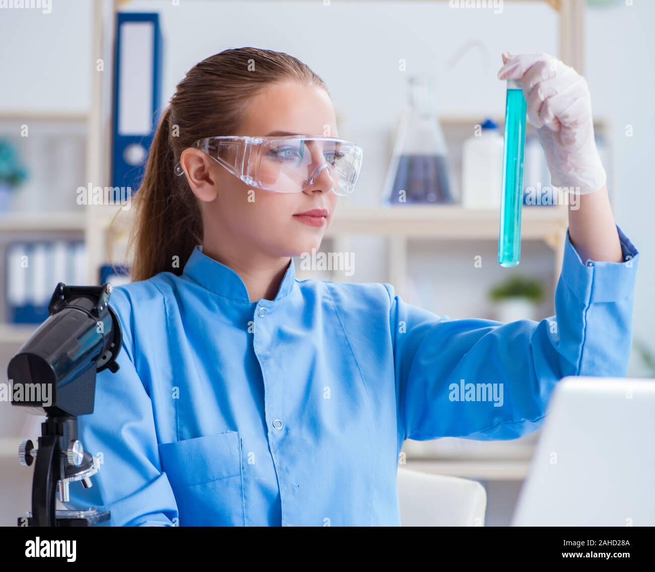Female scientist researcher conducting an experiment in a laboratory ...