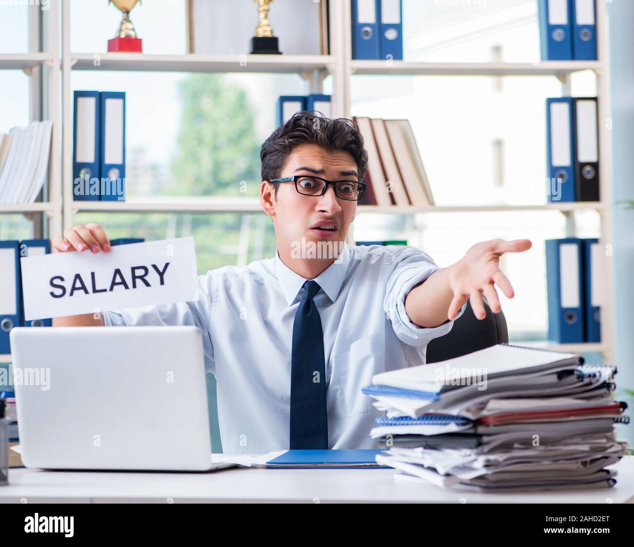 The young businessman asking for salary increase in office Stock Photo ...