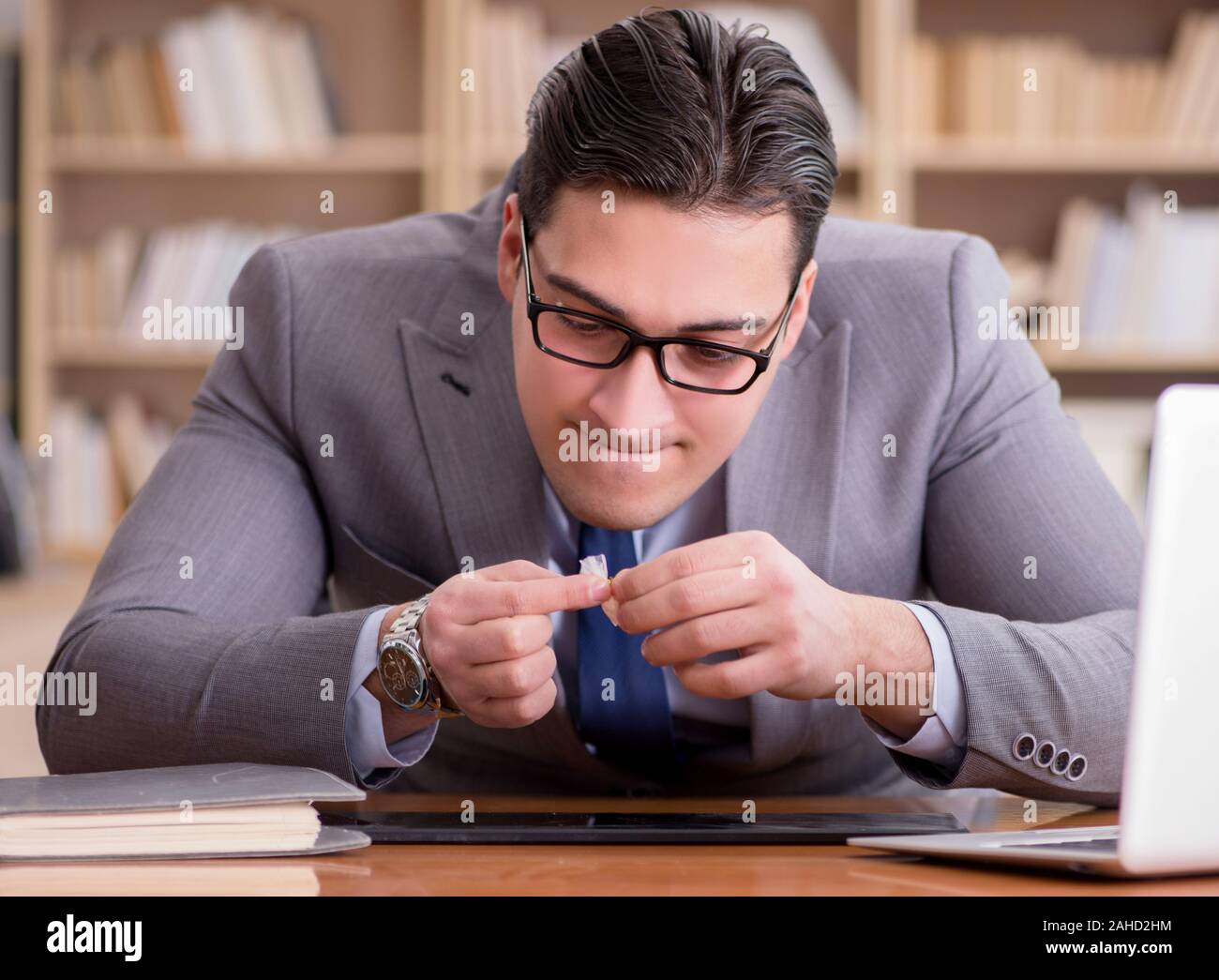 The drug addict businessman in the office Stock Photo - Alamy