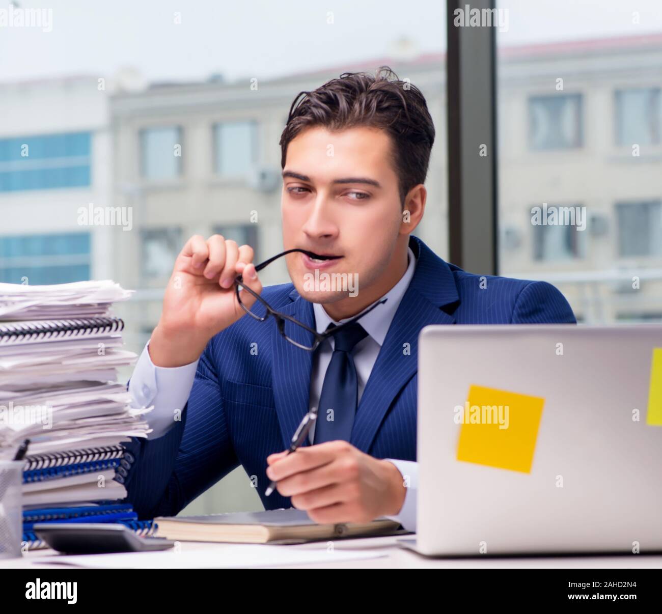 The workaholic businessman overworked with too much work in office ...