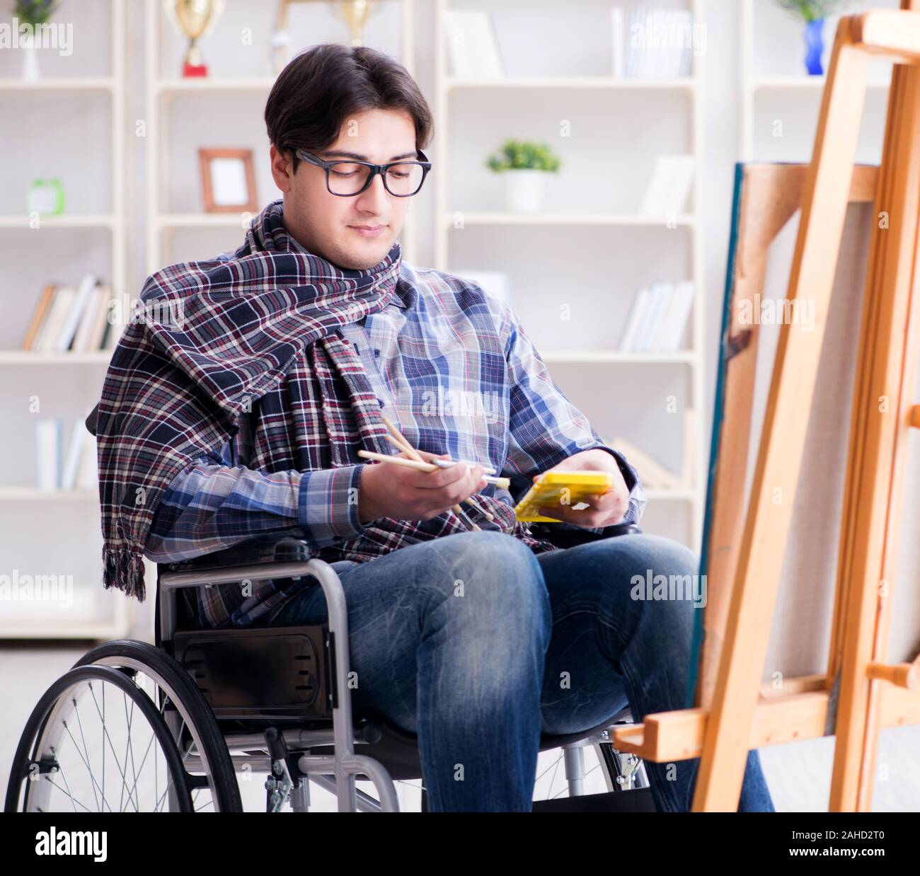 The disabled artist painting picture in studio Stock Photo - Alamy