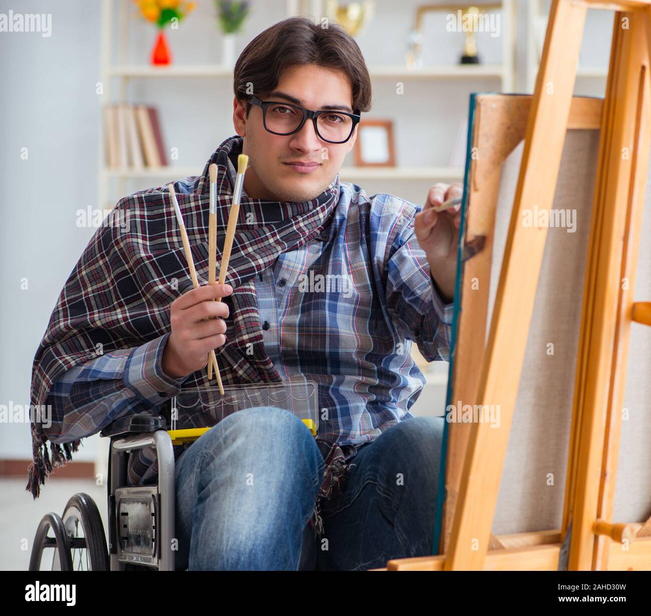 The disabled artist painting picture in studio Stock Photo - Alamy