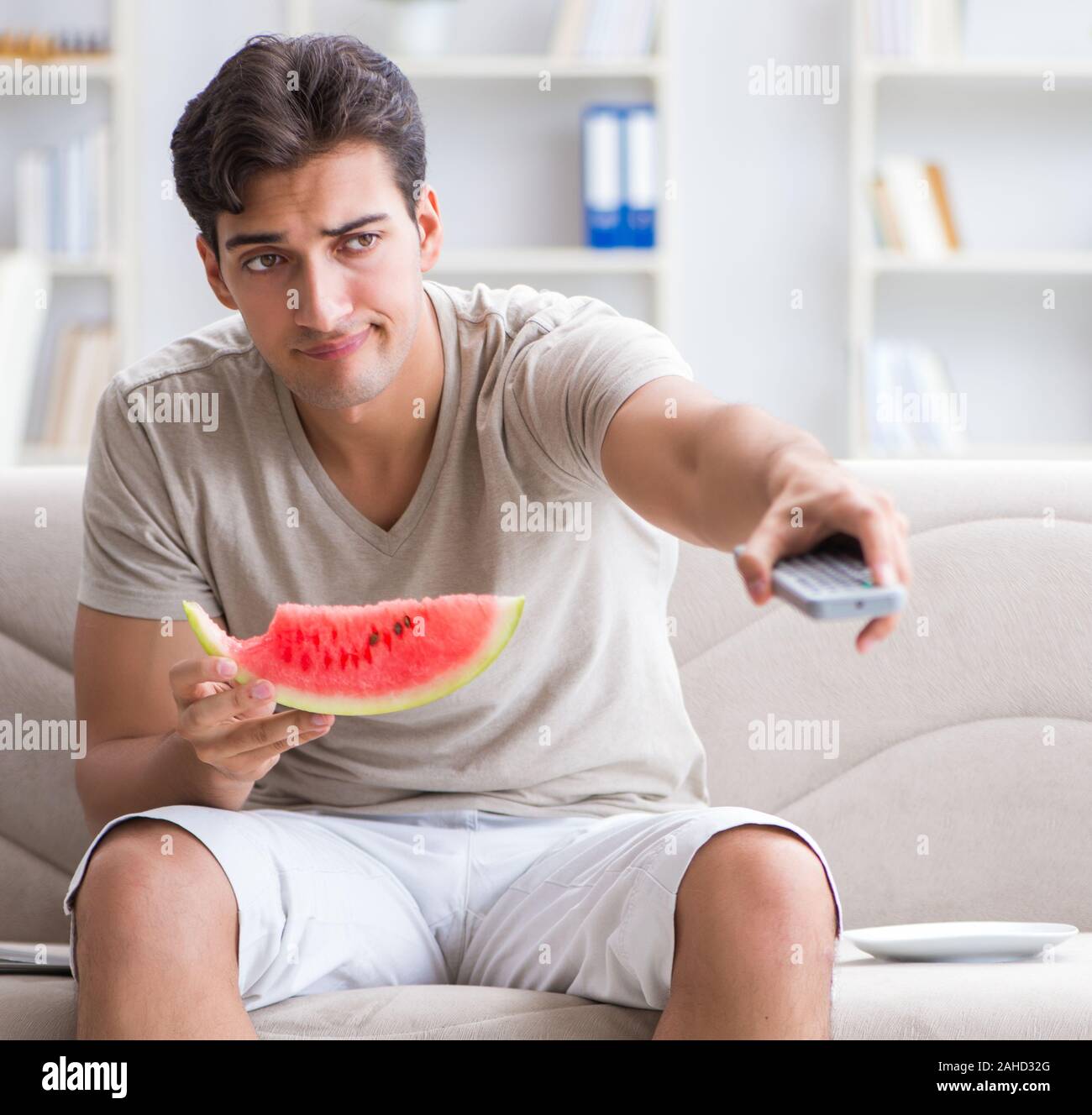 The man eating watermelon at home Stock Photo - Alamy