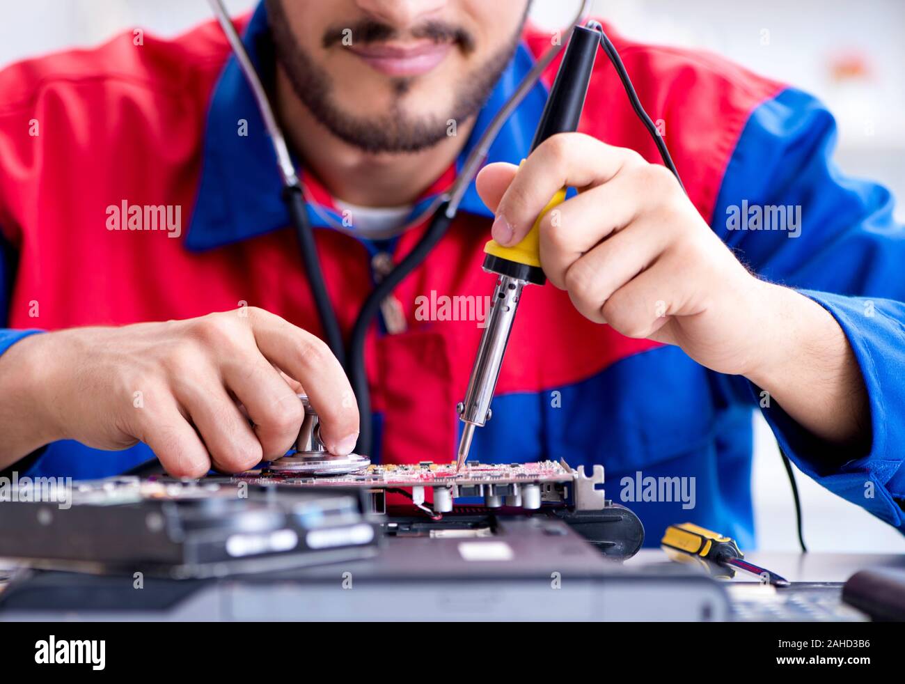 Repairman working in technical support fixing computer laptop ...