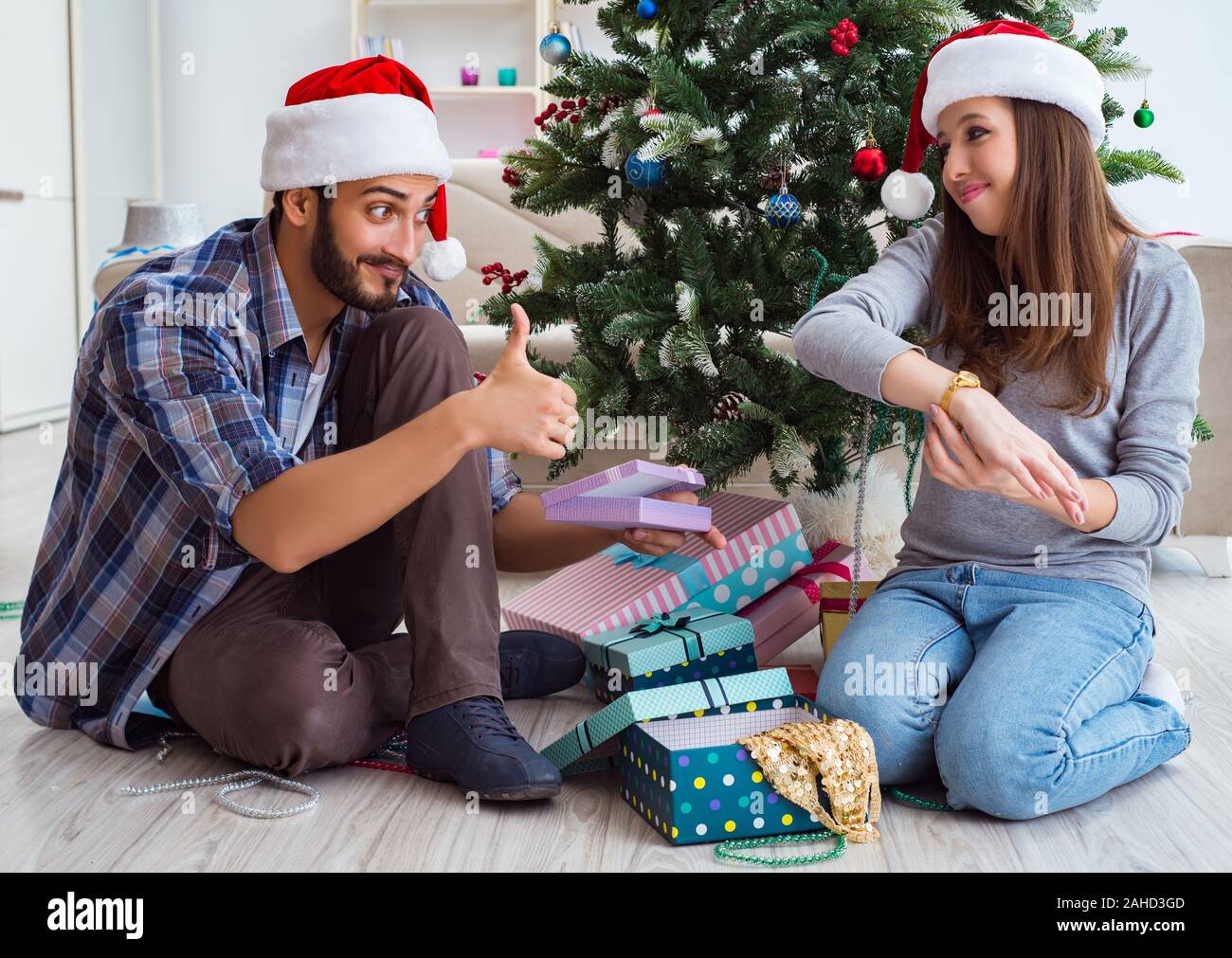 The young woman receiving gold watch as christmas gift Stock Photo - Alamy