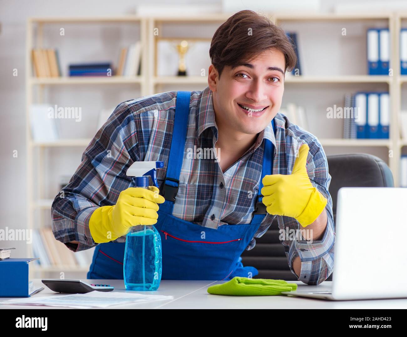 The male cleaner working in the office Stock Photo - Alamy