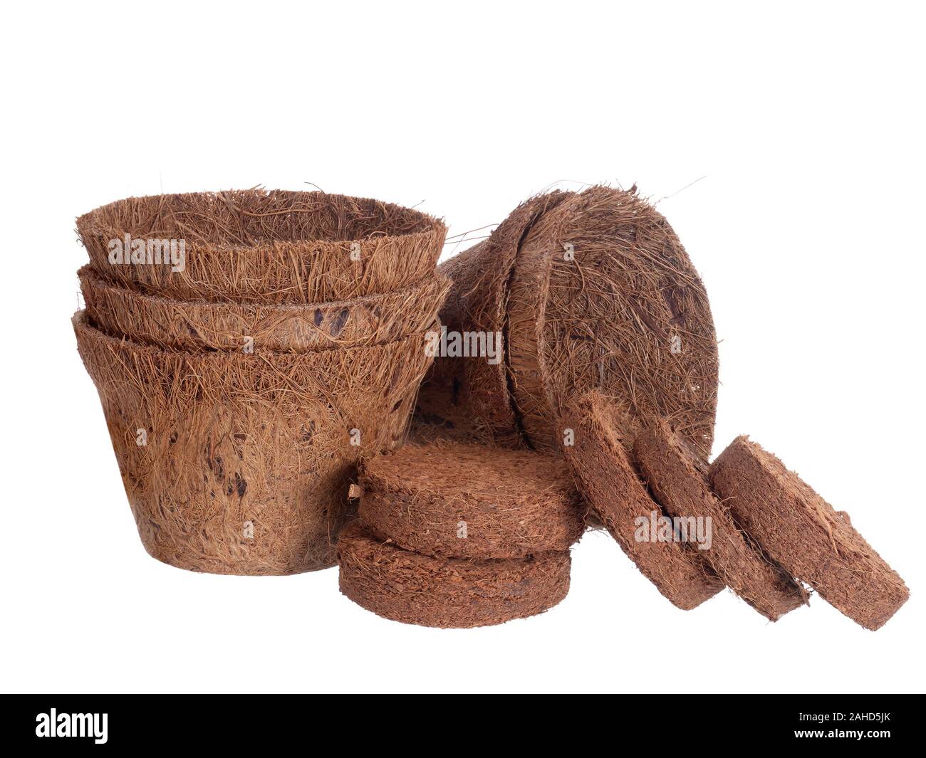 Coir, coconut fibre, plant pots and growing pellets, discs, isolated on ...