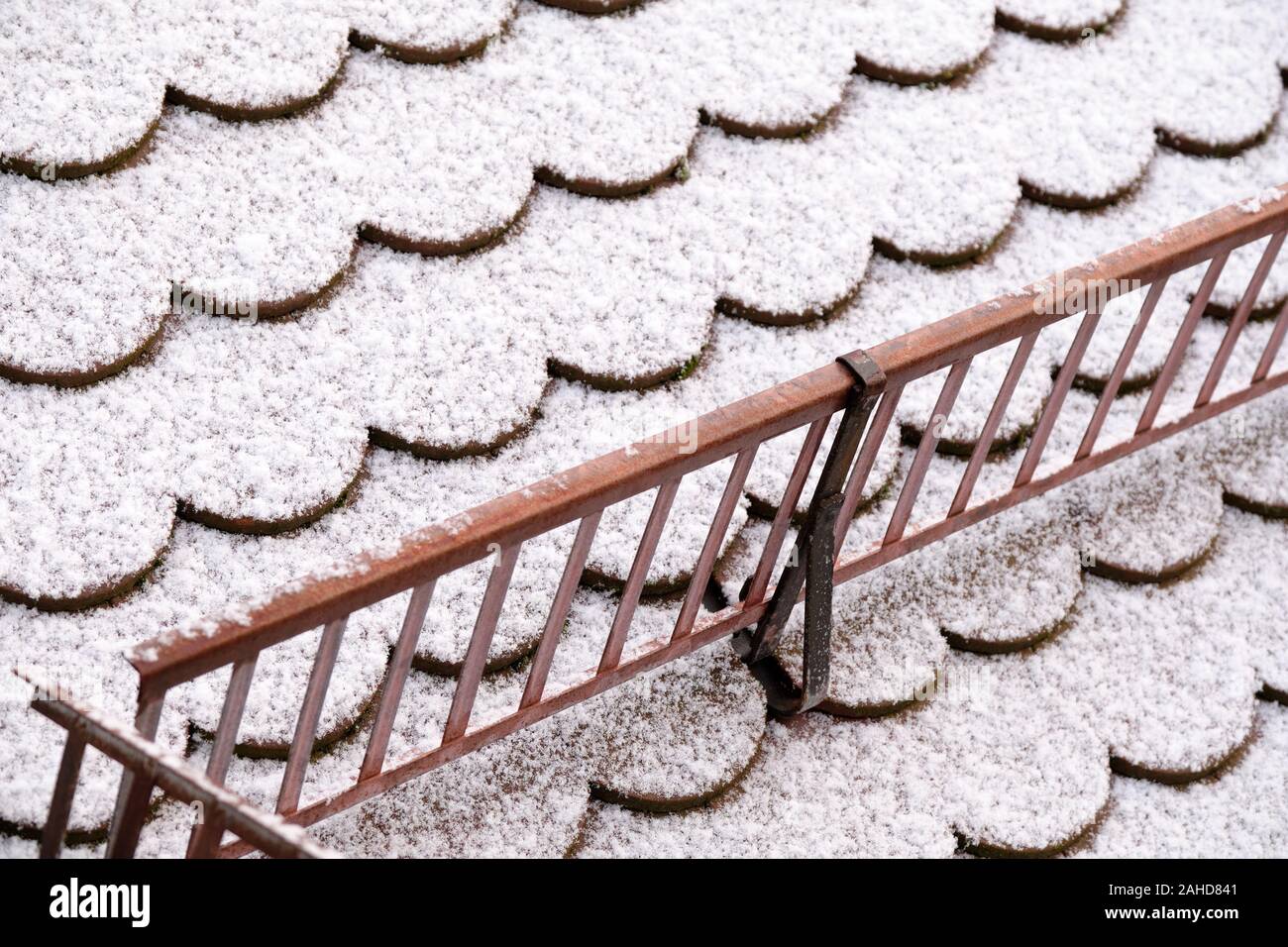 Pattern of a closeup of a roof with plane tiles covered with a thin ...
