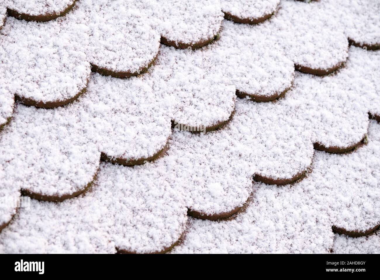Pattern of a closeup of a roof with plane tiles covered with a thin ...