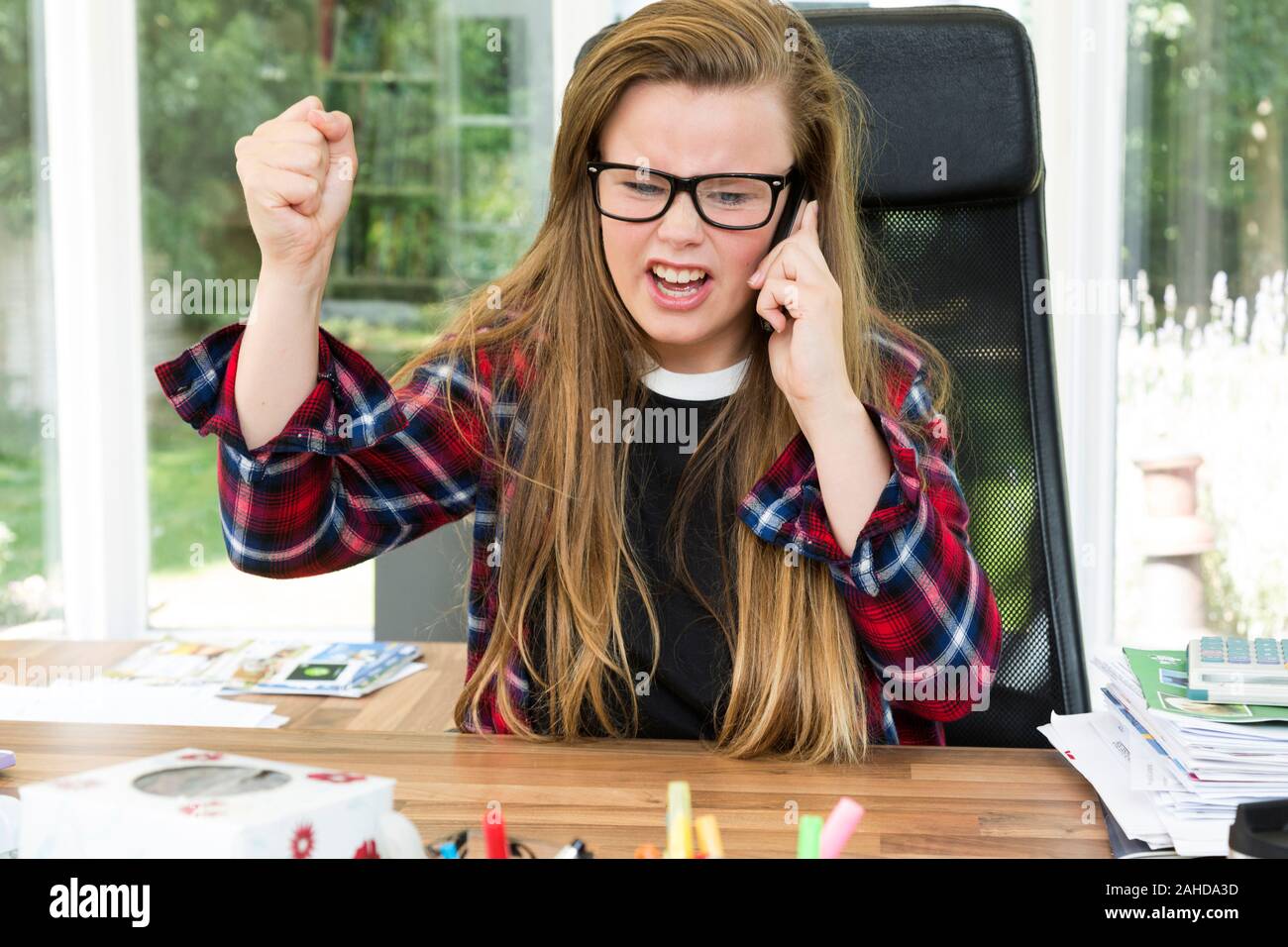 angry young girl talking on phone Stock Photo - Alamy