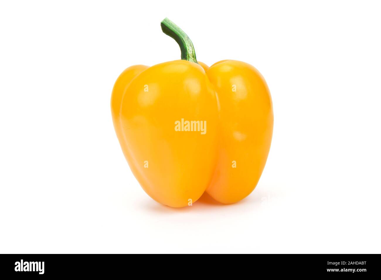 Perfect single yellow peppers isolated on a white background in close ...