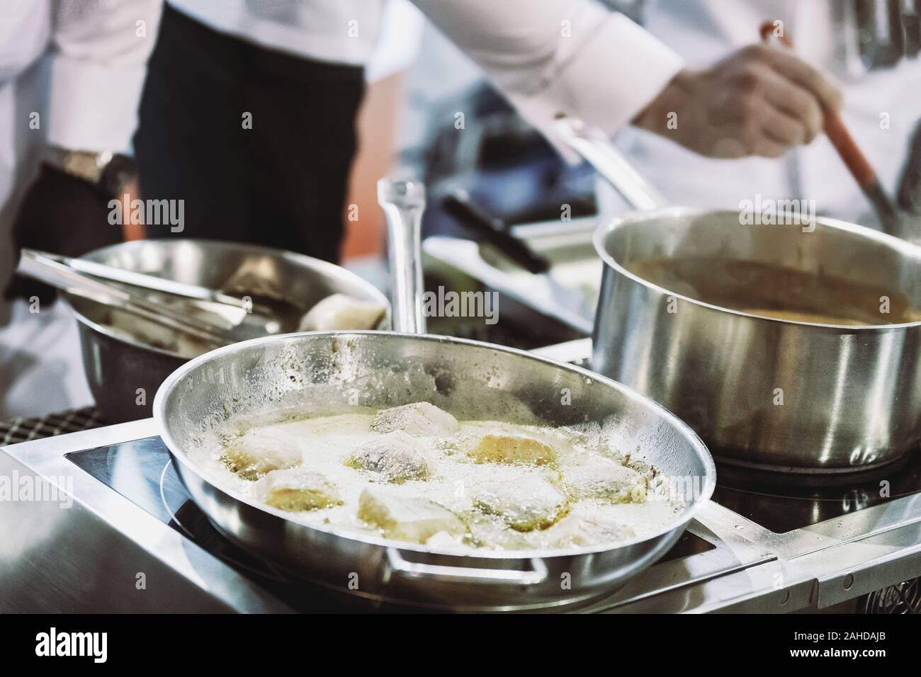 Group of professional chefs work in a restaurant or hotel and prepare a ...