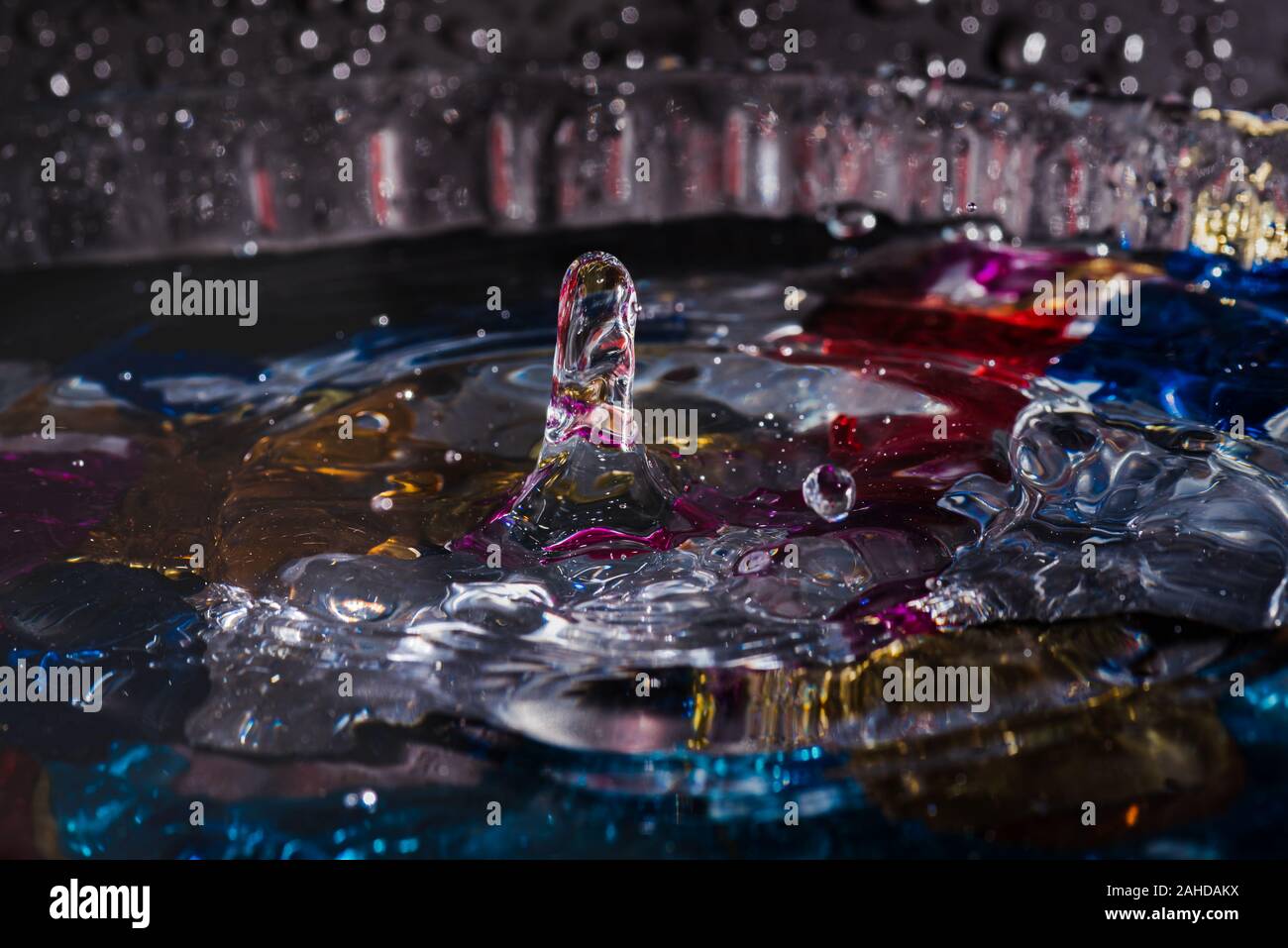 water drops splash forming ripples and waves and abstract water columns ...