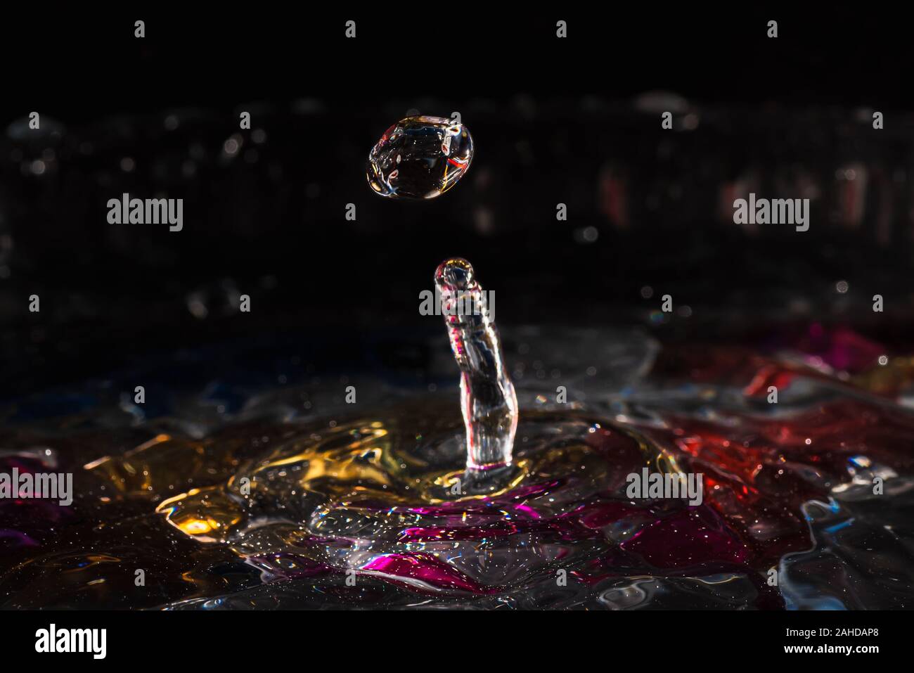 water drops splash forming ripples and waves and abstract water columns ...