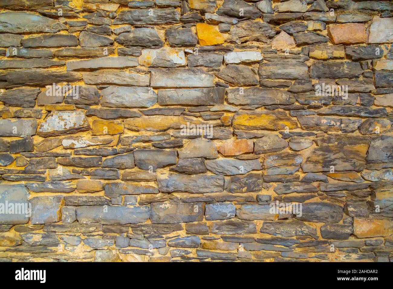 Grunge background of vintage gray and yellow stone brick wall texture ...