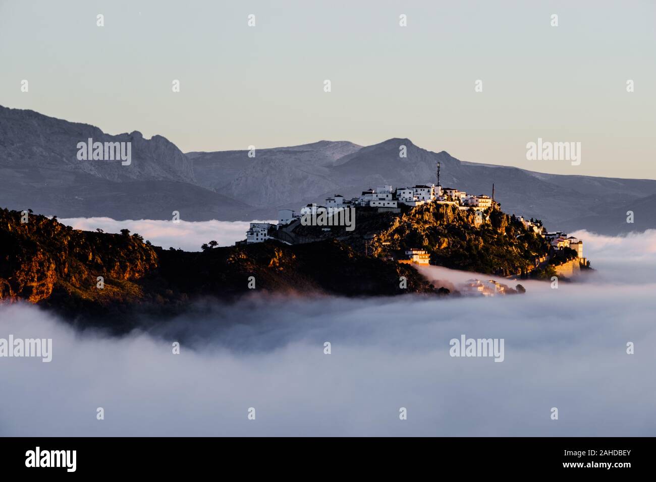 Clouds surrounding the mountain top white village of Comares in ...