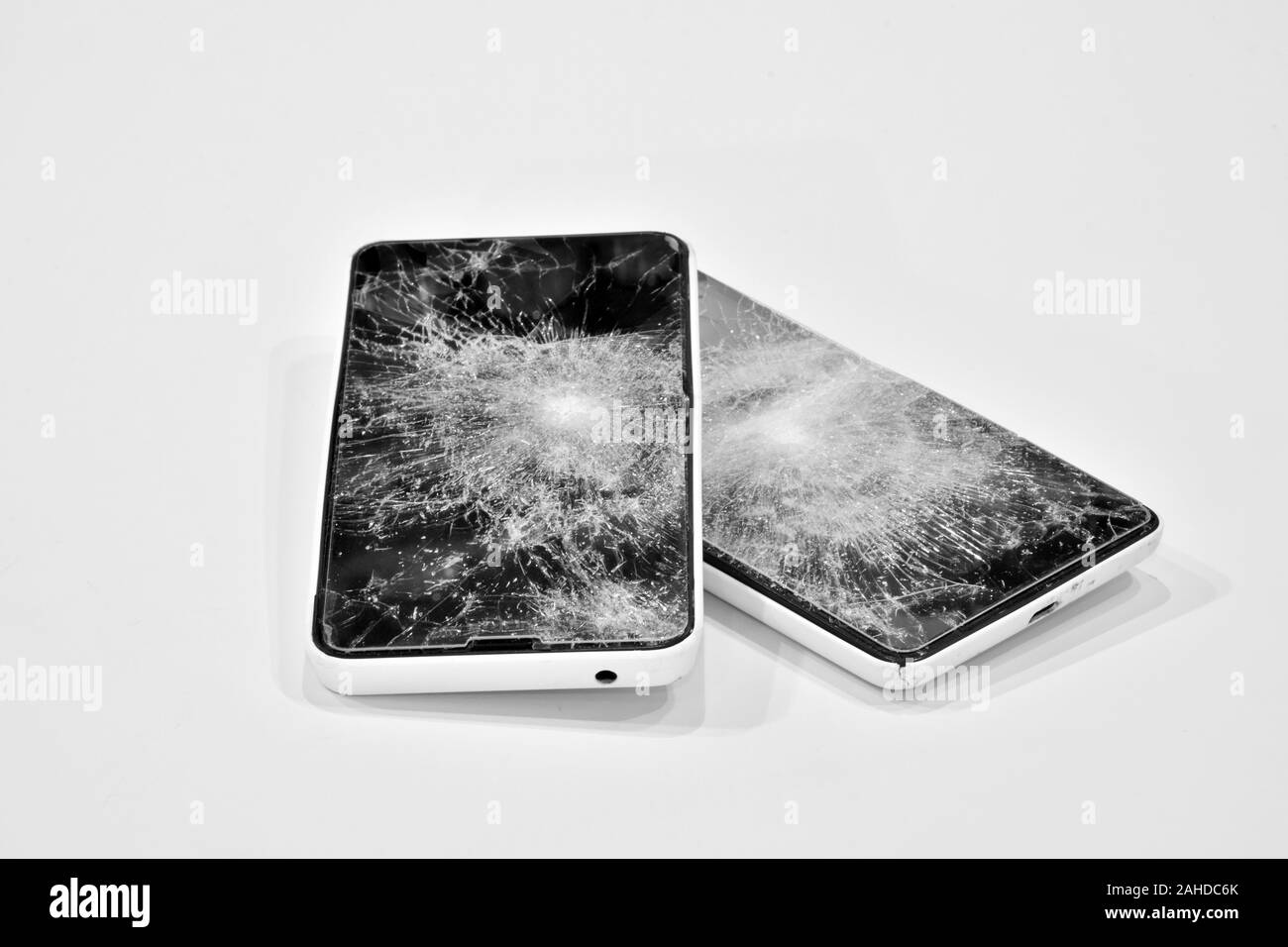 Cell phone with the screen broken by a hammer. Smart phone with the ...