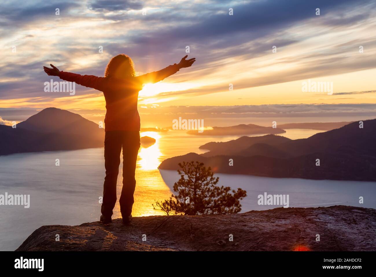 Adventurous Caucasian Girl standing on top of a mountain Stock Photo ...