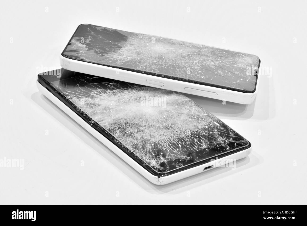 Cell phone with the screen broken by a hammer. Smart phone with the ...