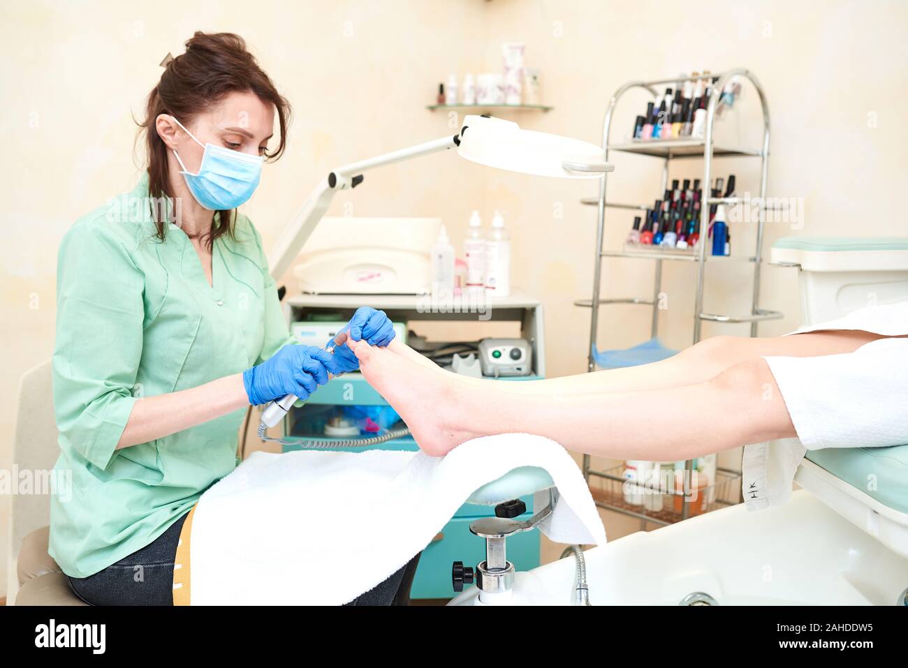 Woman's feet receiving a pedicure. Beautician doing pedicure. Close up ...