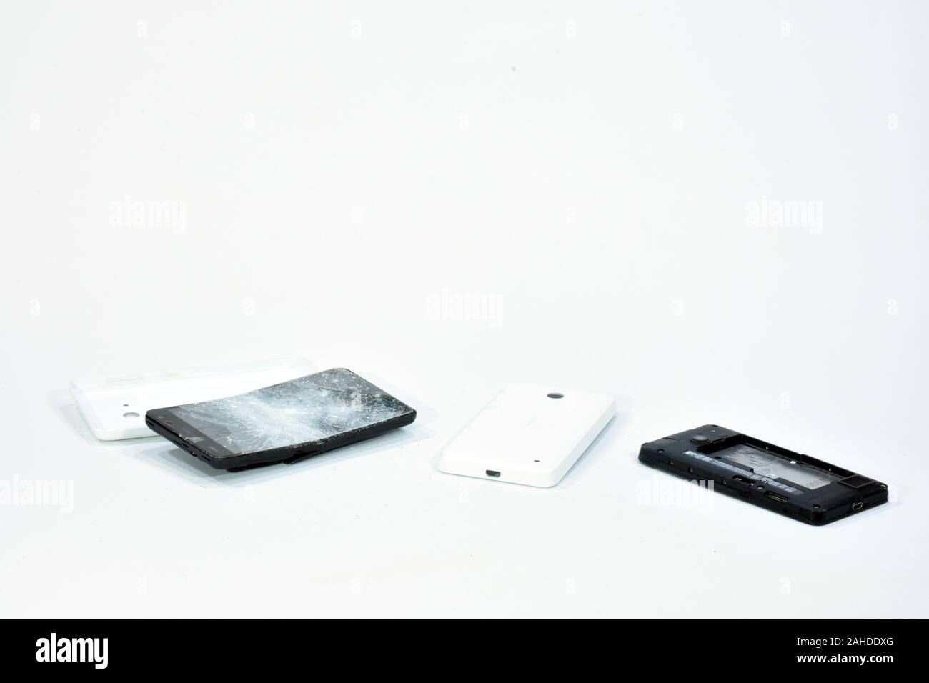 Cell phone with the screen broken by a hammer. Smart phone with the ...