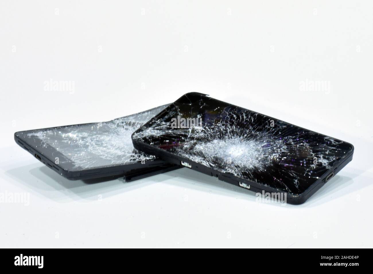 Cell phone with the screen broken by a hammer. Smart phone with the ...