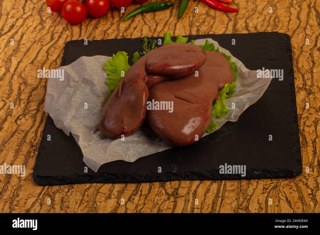Raw pork kidneys ower wooden background Stock Photo - Alamy