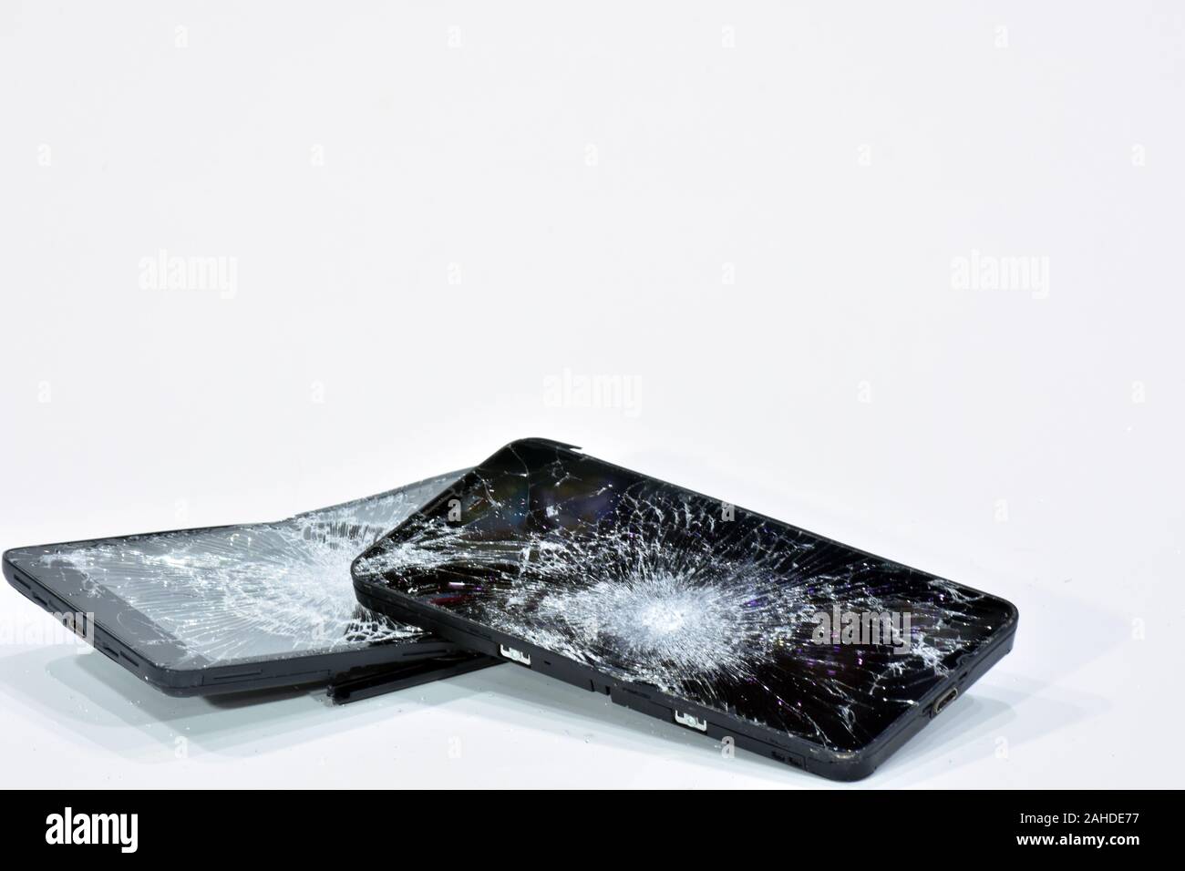 Cell phone with the screen broken by a hammer. Smart phone with the ...