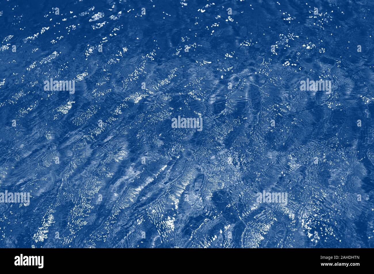 Pattern water texture in a swimming pool. Classic blue toning trend ...