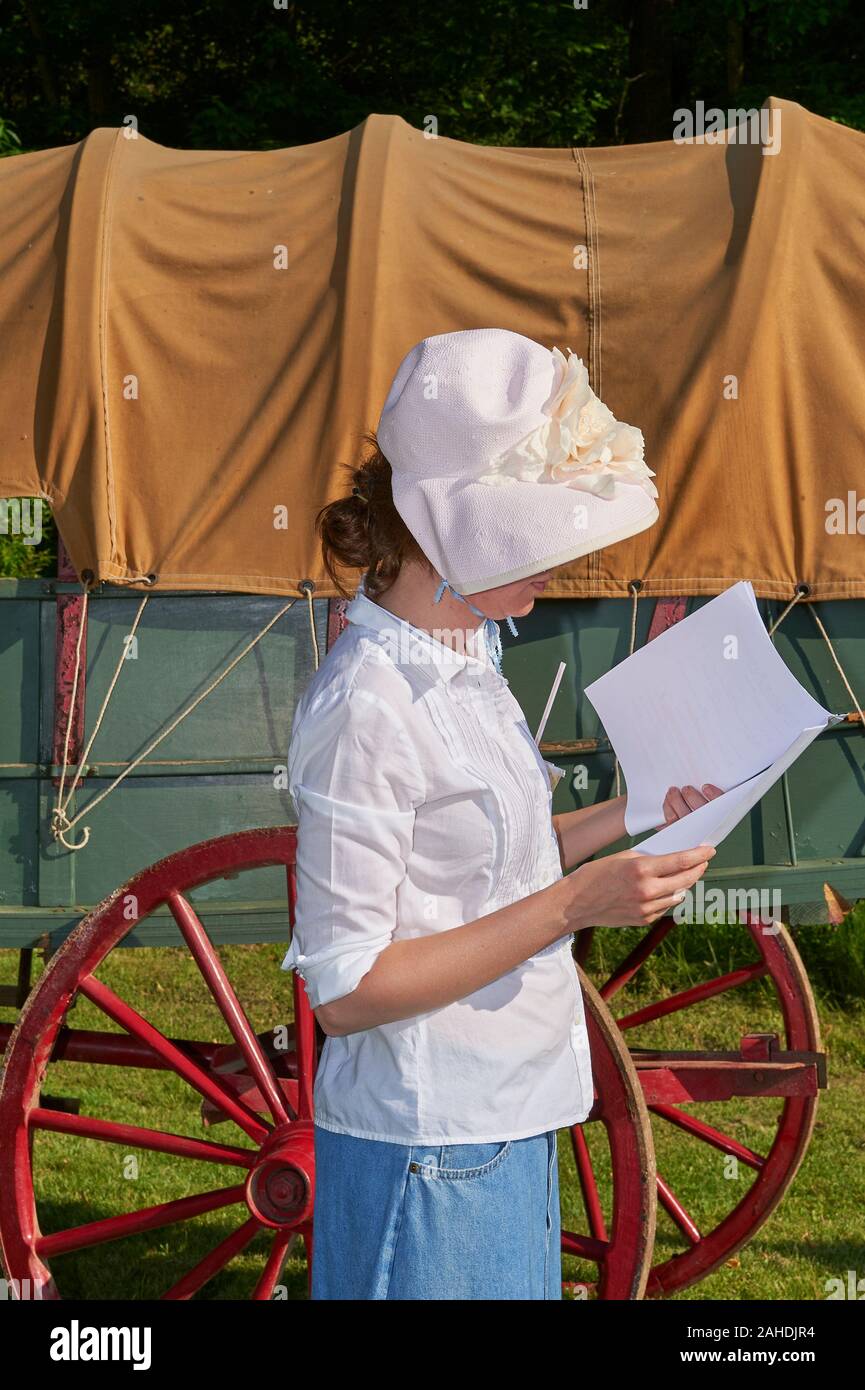 actor studying lines in front of conestoga wagon Stock Photo - Alamy