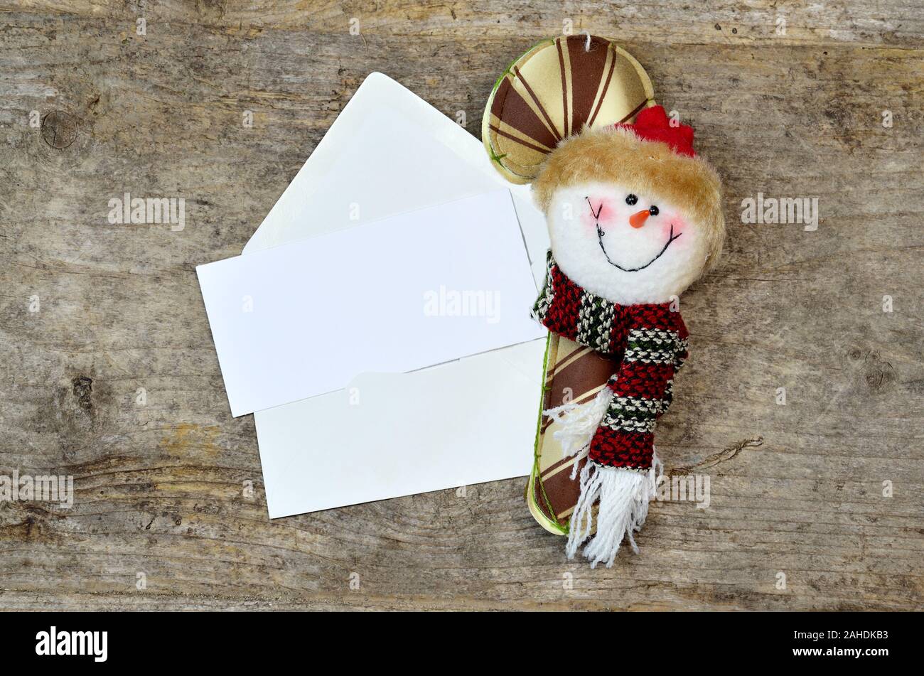 Christmas blank card –note with toy of a snowman face on a candy cane ...