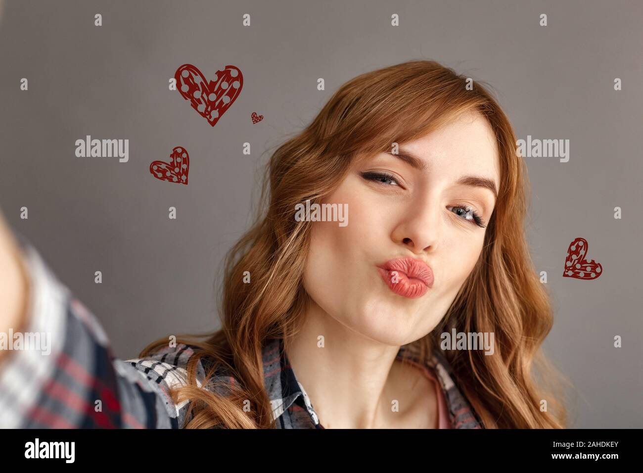 Young stylish woman studio standing isolated on grey background taking ...