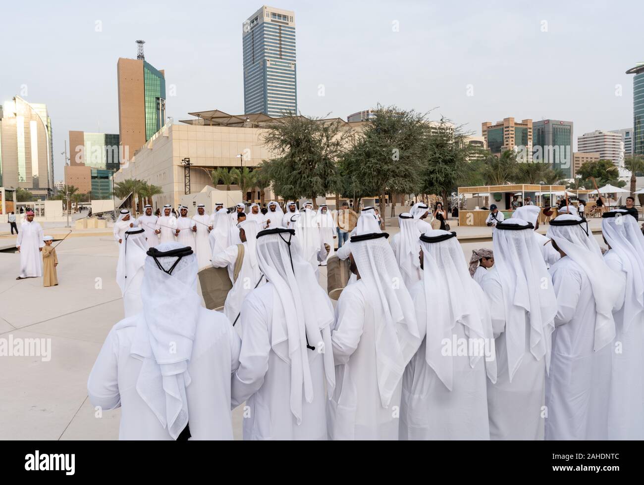 Arabic men standing in traditional cloth around modern buildings ...