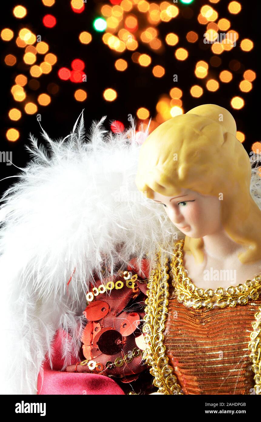 Portrait of an angle doll angle on a flare light dots background Stock ...