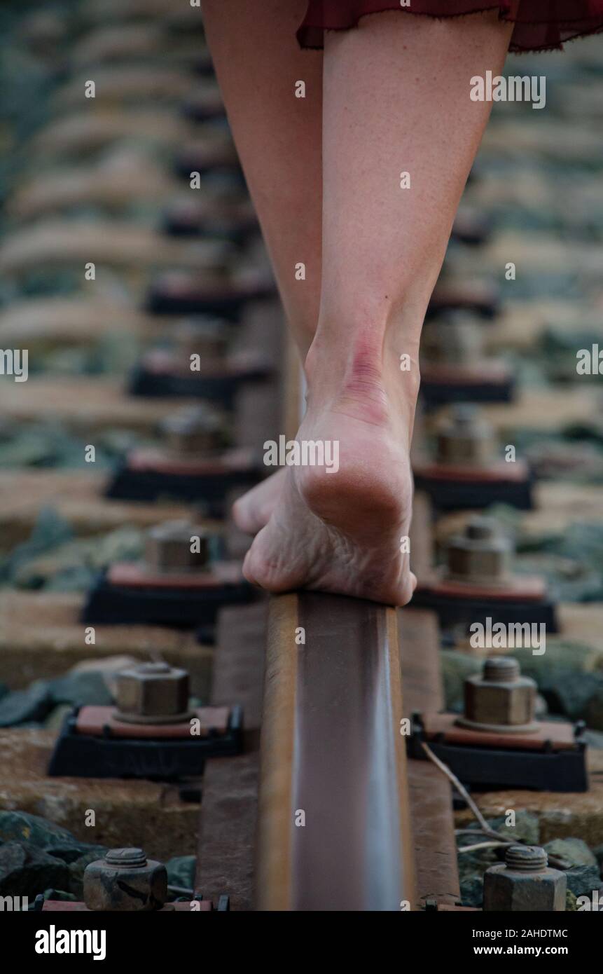 Bare feet walking on the train track Stock Photo - Alamy