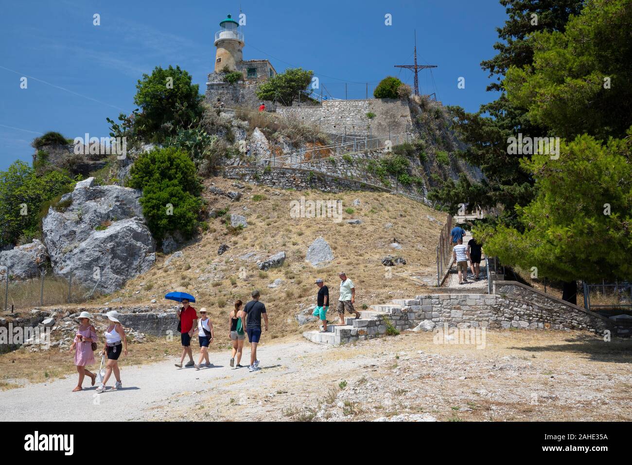Tourists walking the pathway up to the Old Fortress lighthouse, Corfu ...