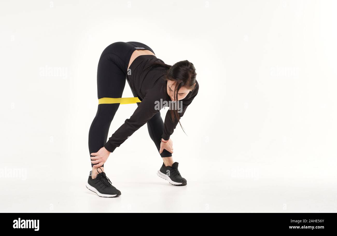 Young athletic woman making yoga and gymnastics stretching exercises ...