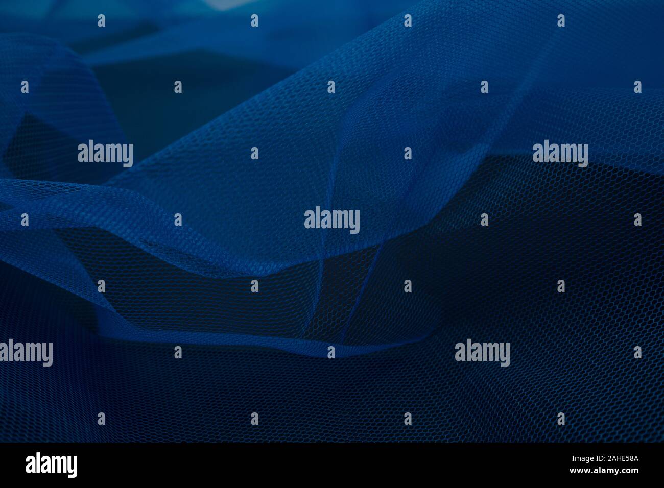 Beautiful close up of blue tulle fabric with textile texture background ...