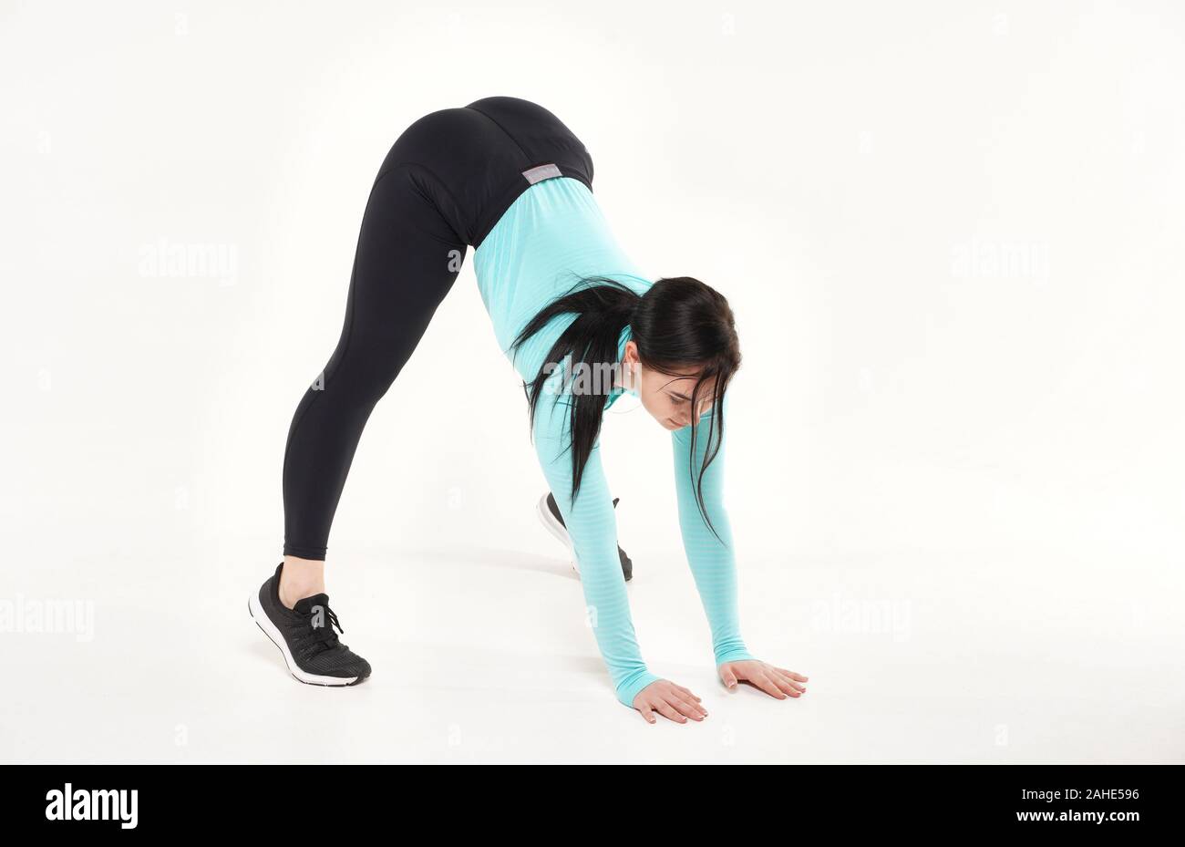 Young athletic woman making yoga and gymnastics stretching exercises ...
